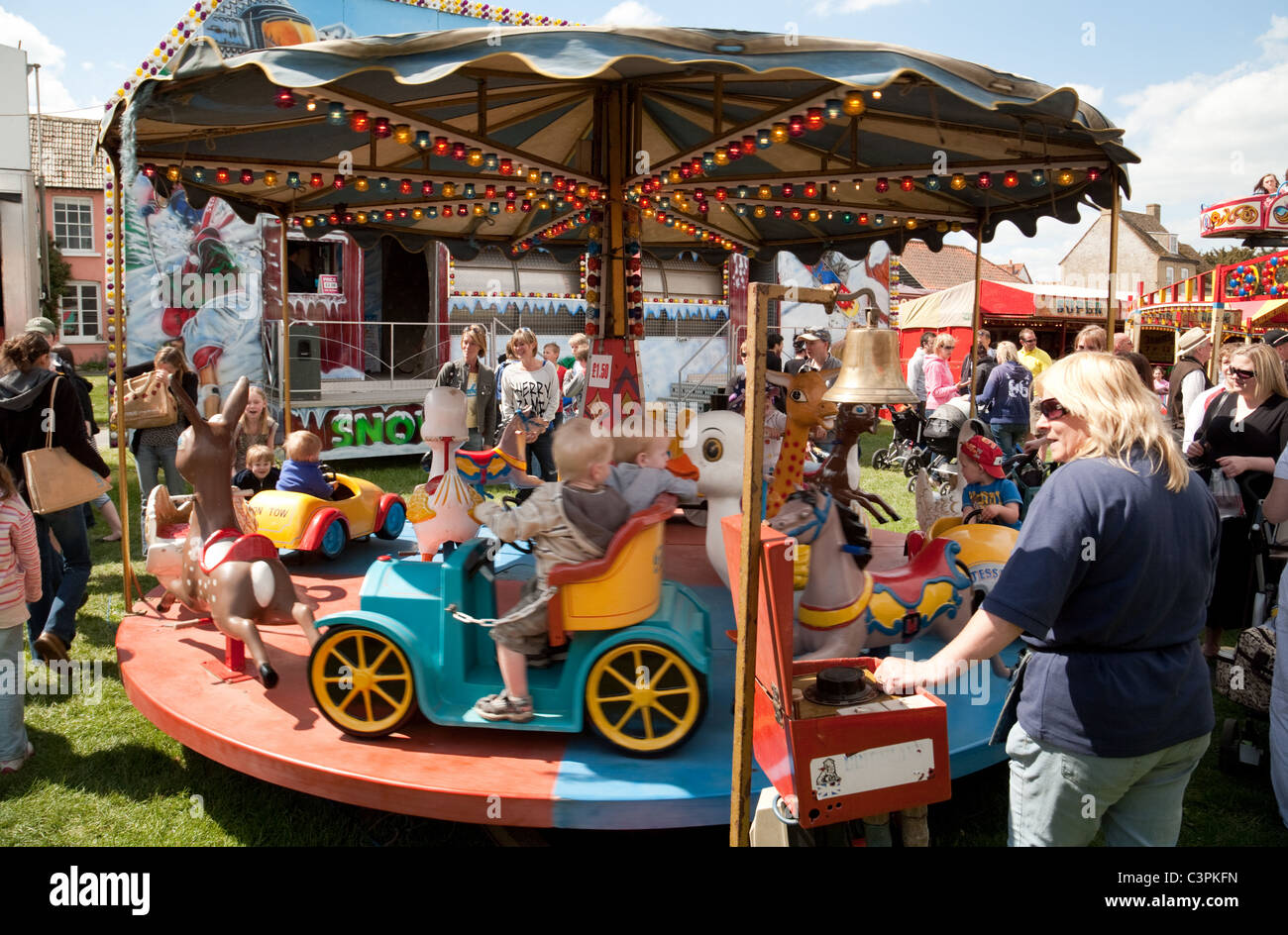 Children on a roundabout at a fun fair hi-res stock photography and ...