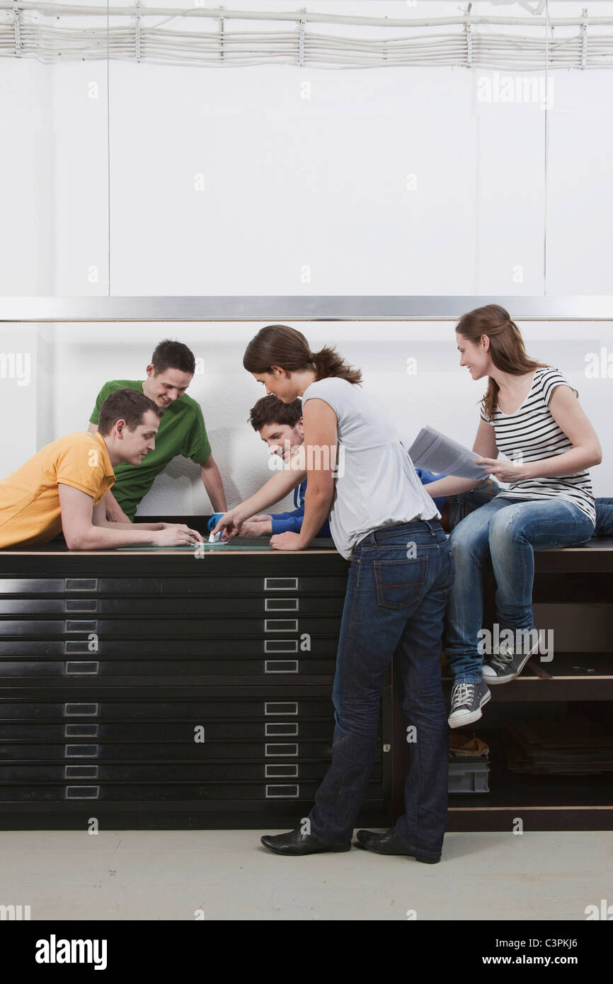 Friends busy at work Stock Photo - Alamy