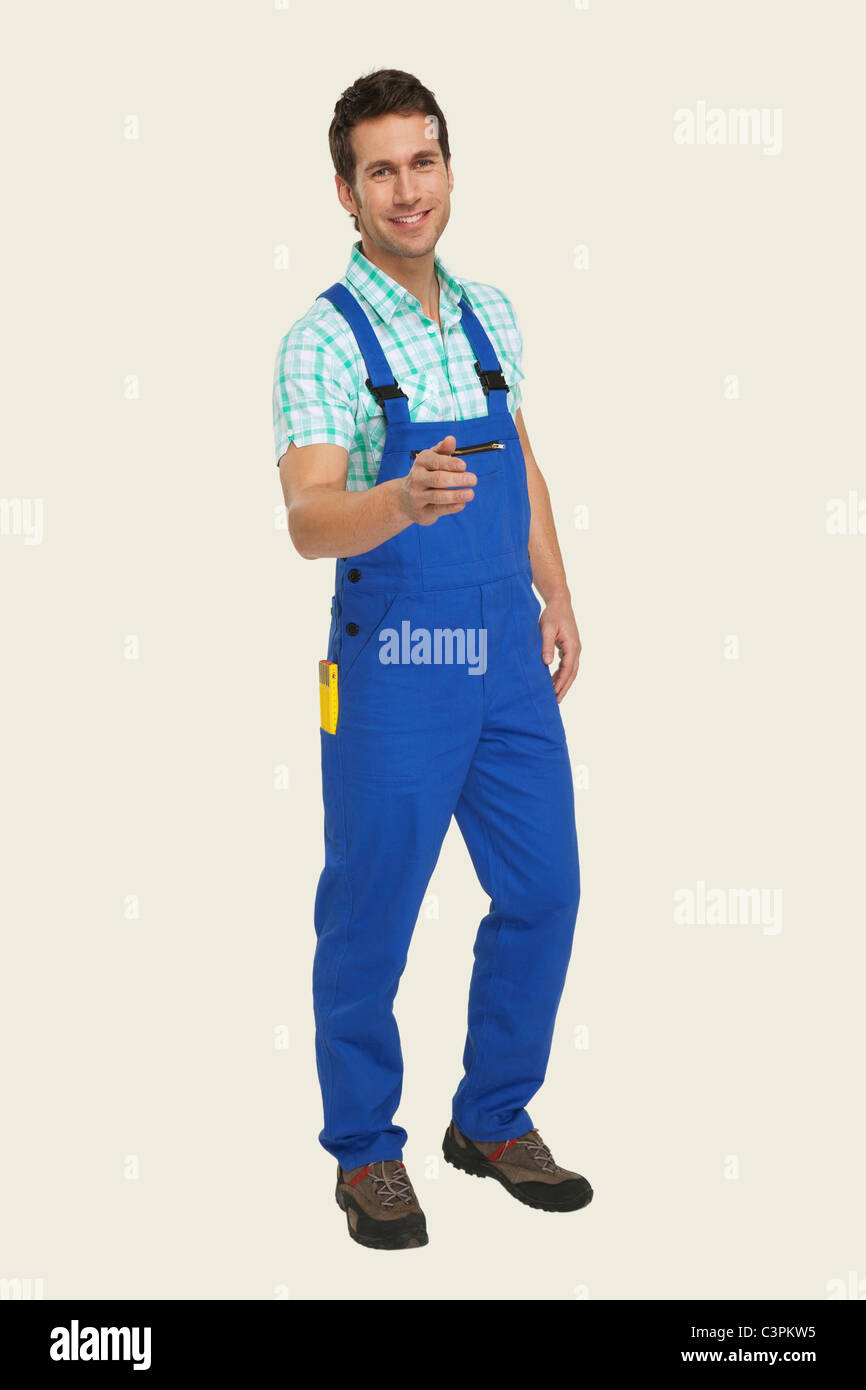 Man in overall smiling, portrait Stock Photo - Alamy