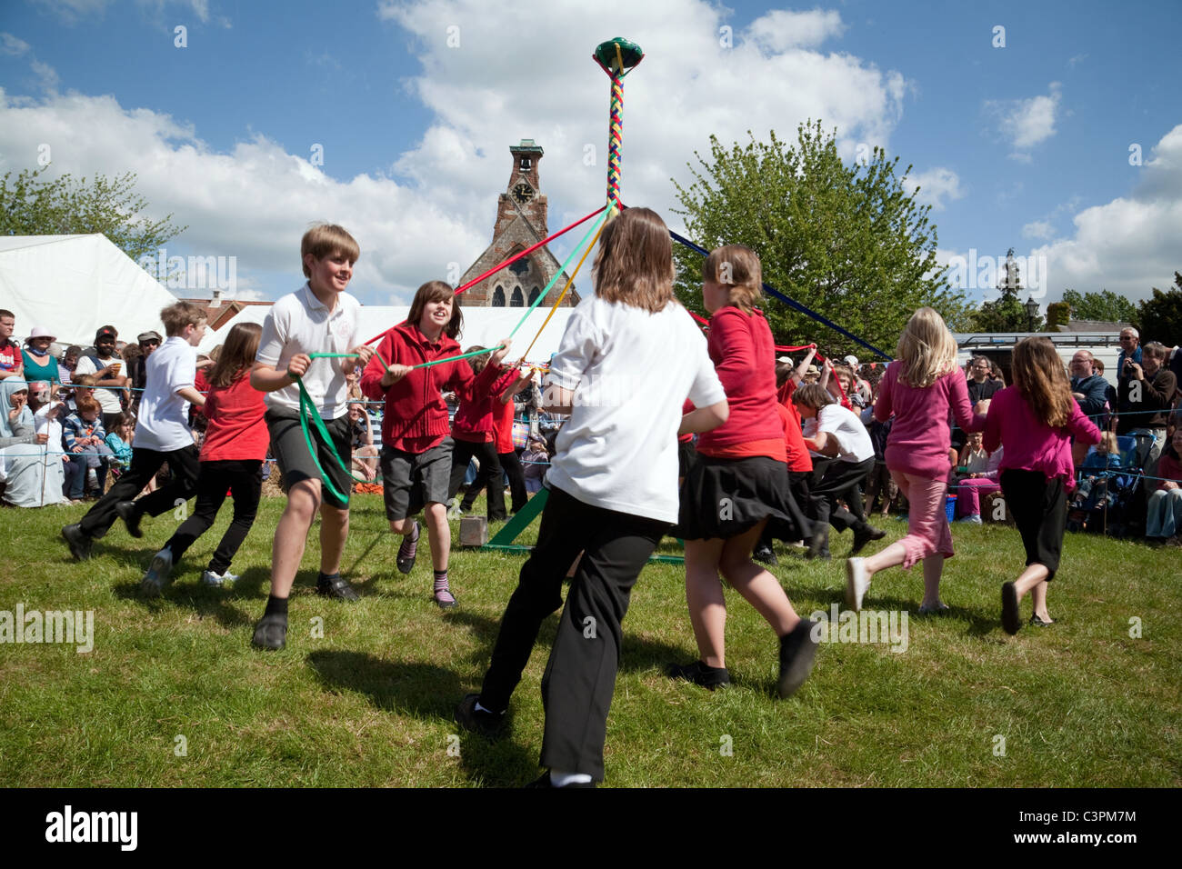 Children from a local primary school dancing round the maypole on May ...