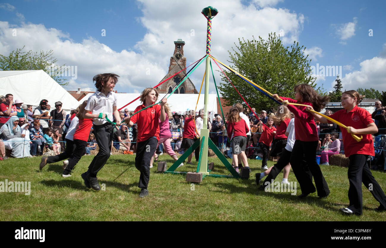 Children from a local primary school dancing round the maypole on May ...