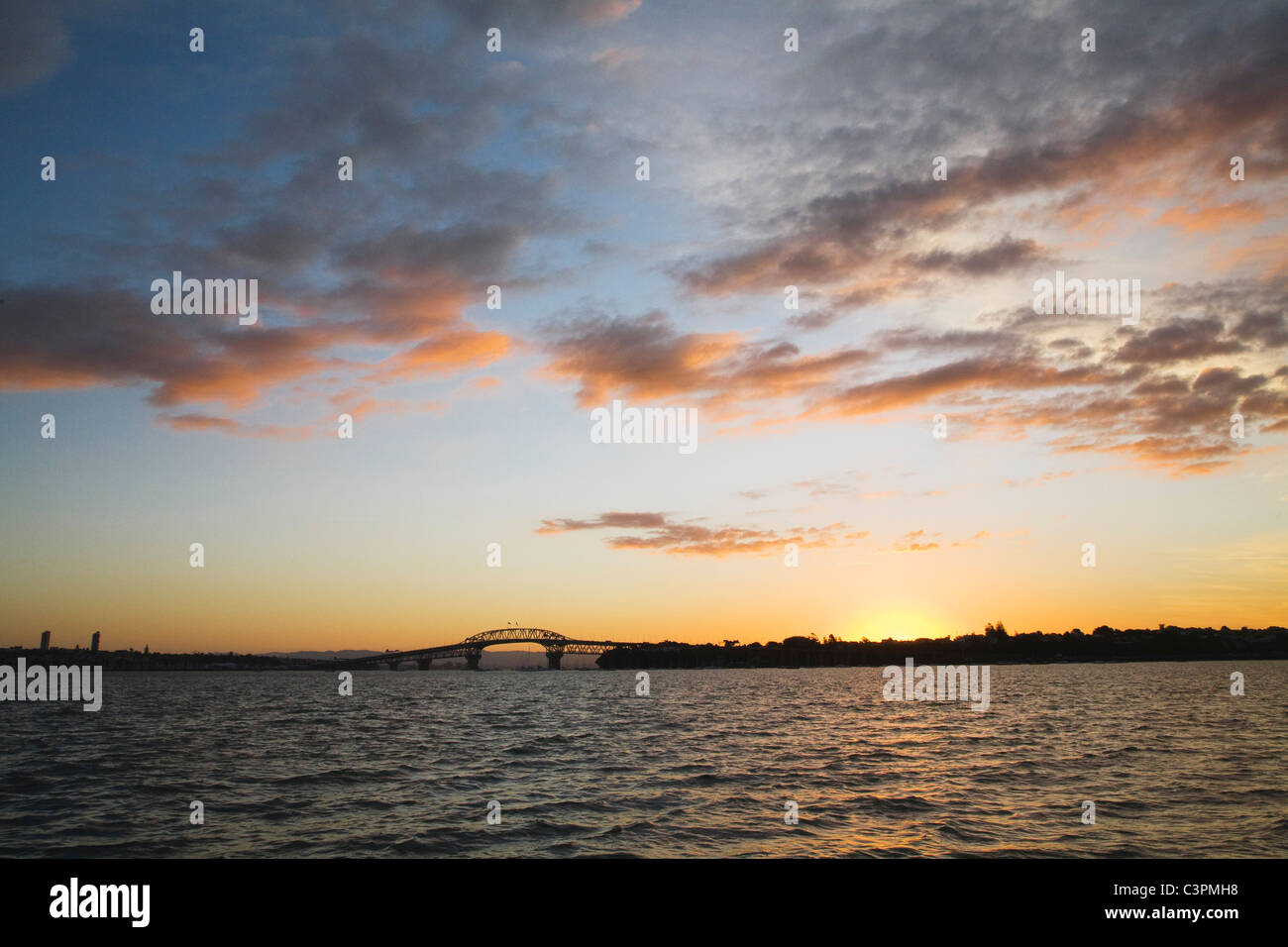 New Zealand, Auckland, North Island, View of harbour bridge at sunset ...