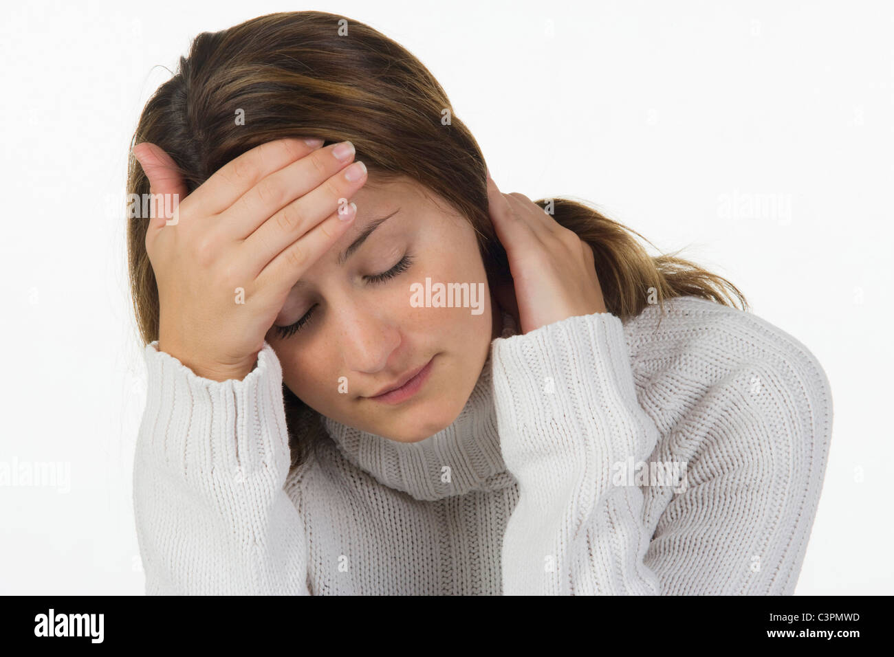Young woman, hands on head looking down Stock Photo - Alamy