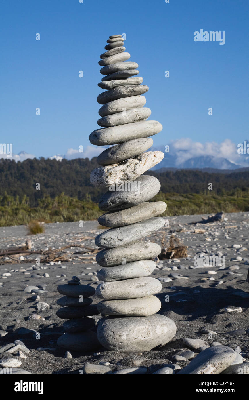 New Zealand, South Island, West Coast, Piles of Stones in beach with ...