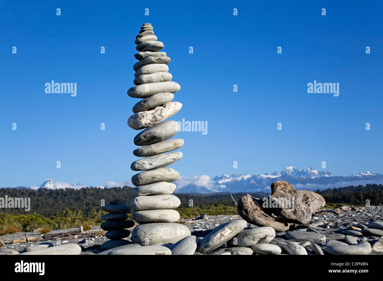New Zealand, South Island, West Coast, Piles of Stones in beach with ...