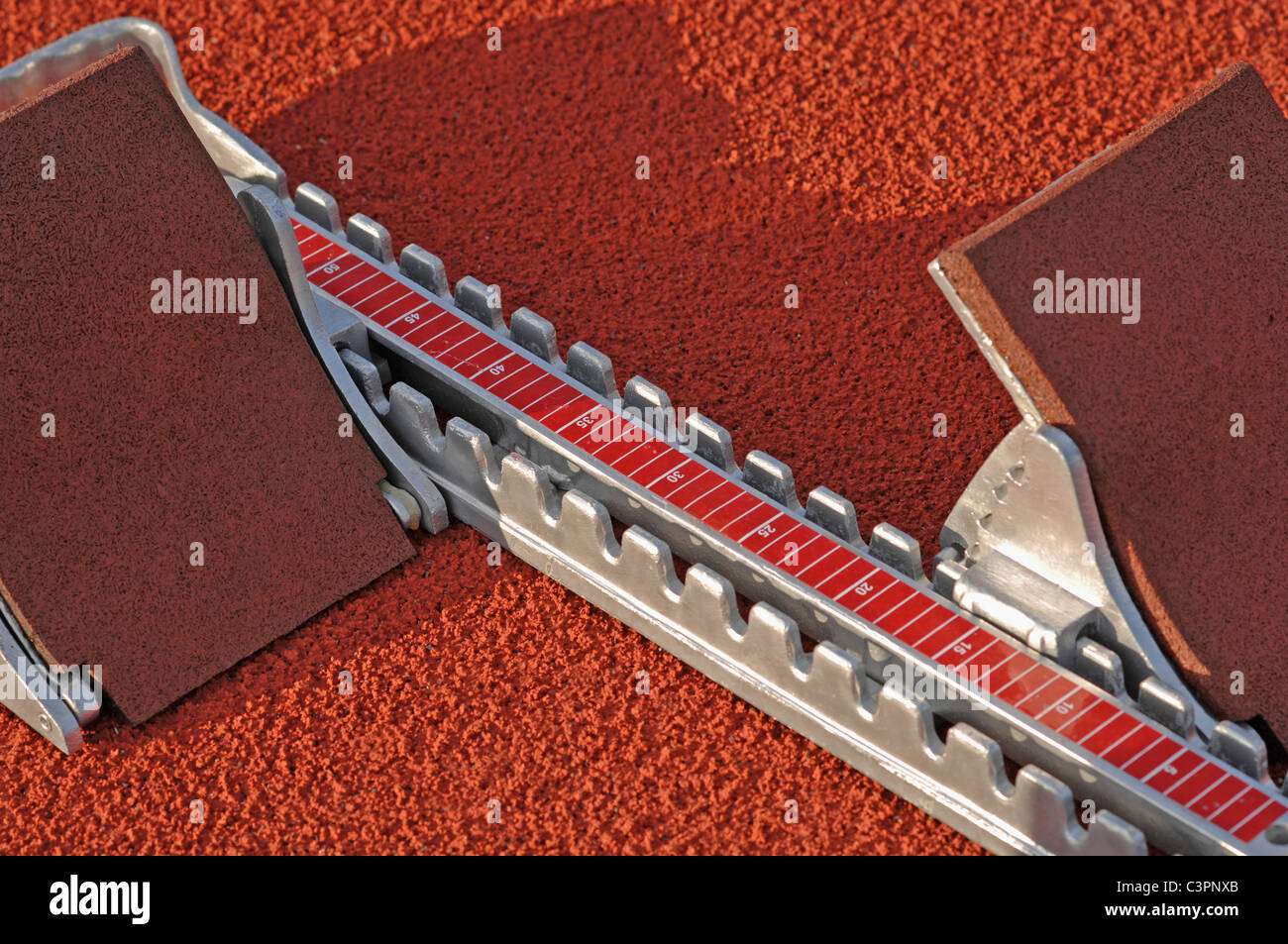 Starting blocks on running track, close up Stock Photo - Alamy