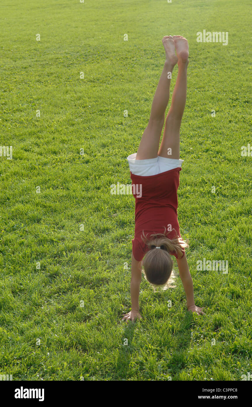 Child doing headstand hi-res stock photography and images - Alamy