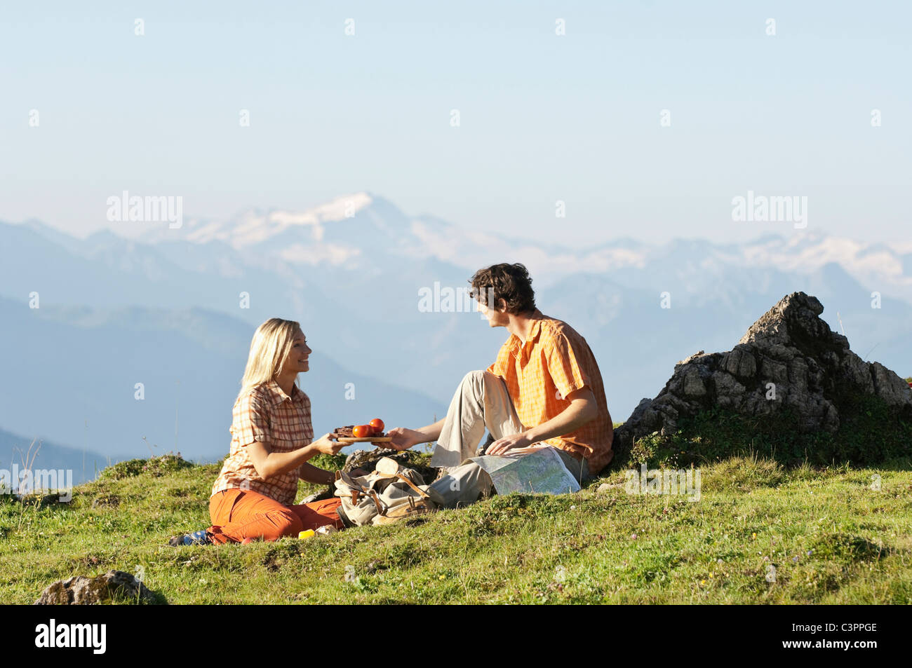 Young couple sitting face to face sharing breakfast Stock Photo - Alamy
