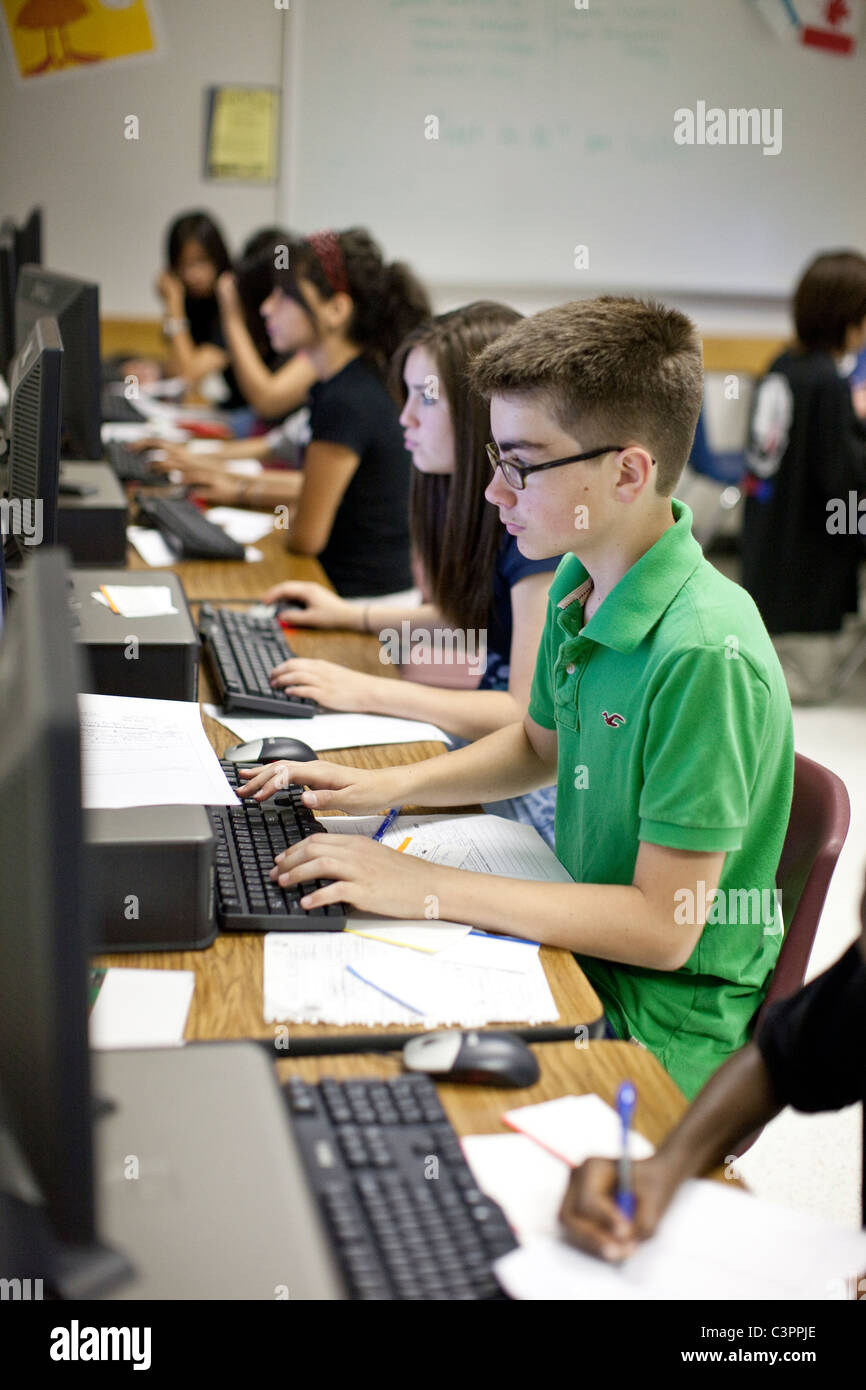 Group of middle school students work independently using computers ...
