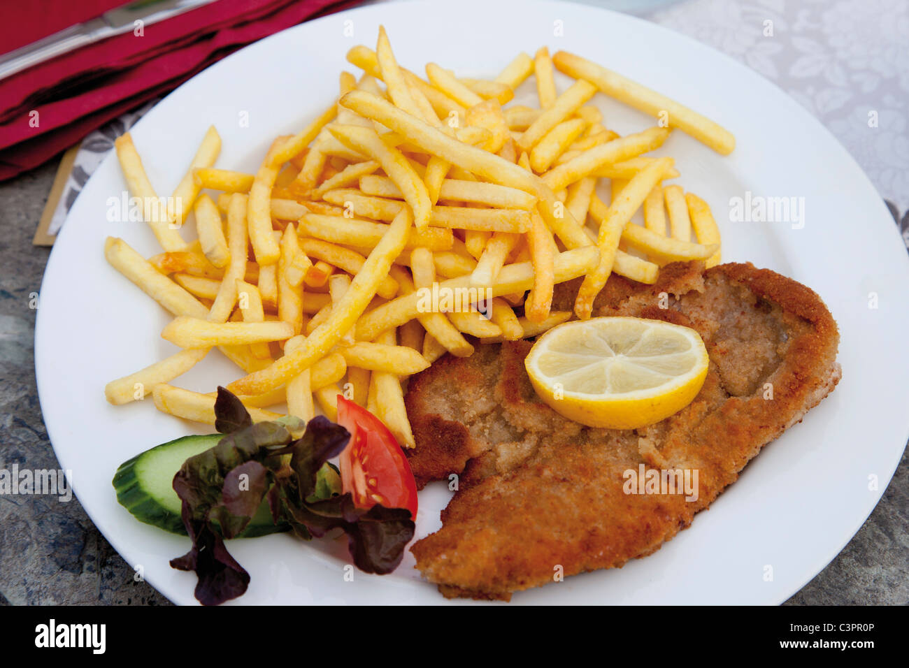 Schnitzel with chips in plate, close up Stock Photo - Alamy