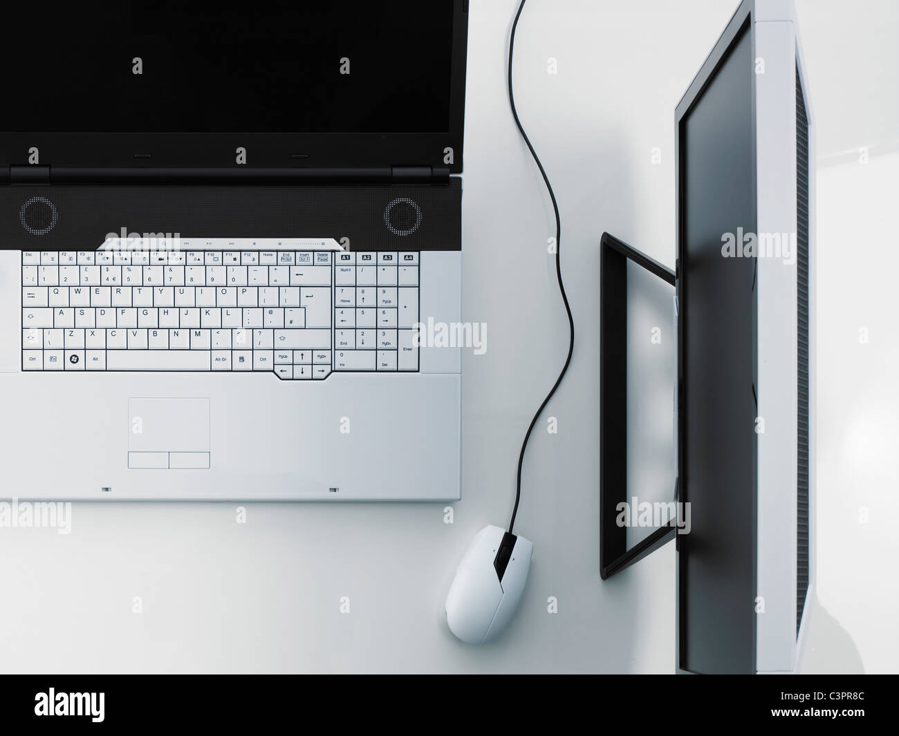 Germany, Neulautern, Computer monitor, laptop and mouse on table Stock ...