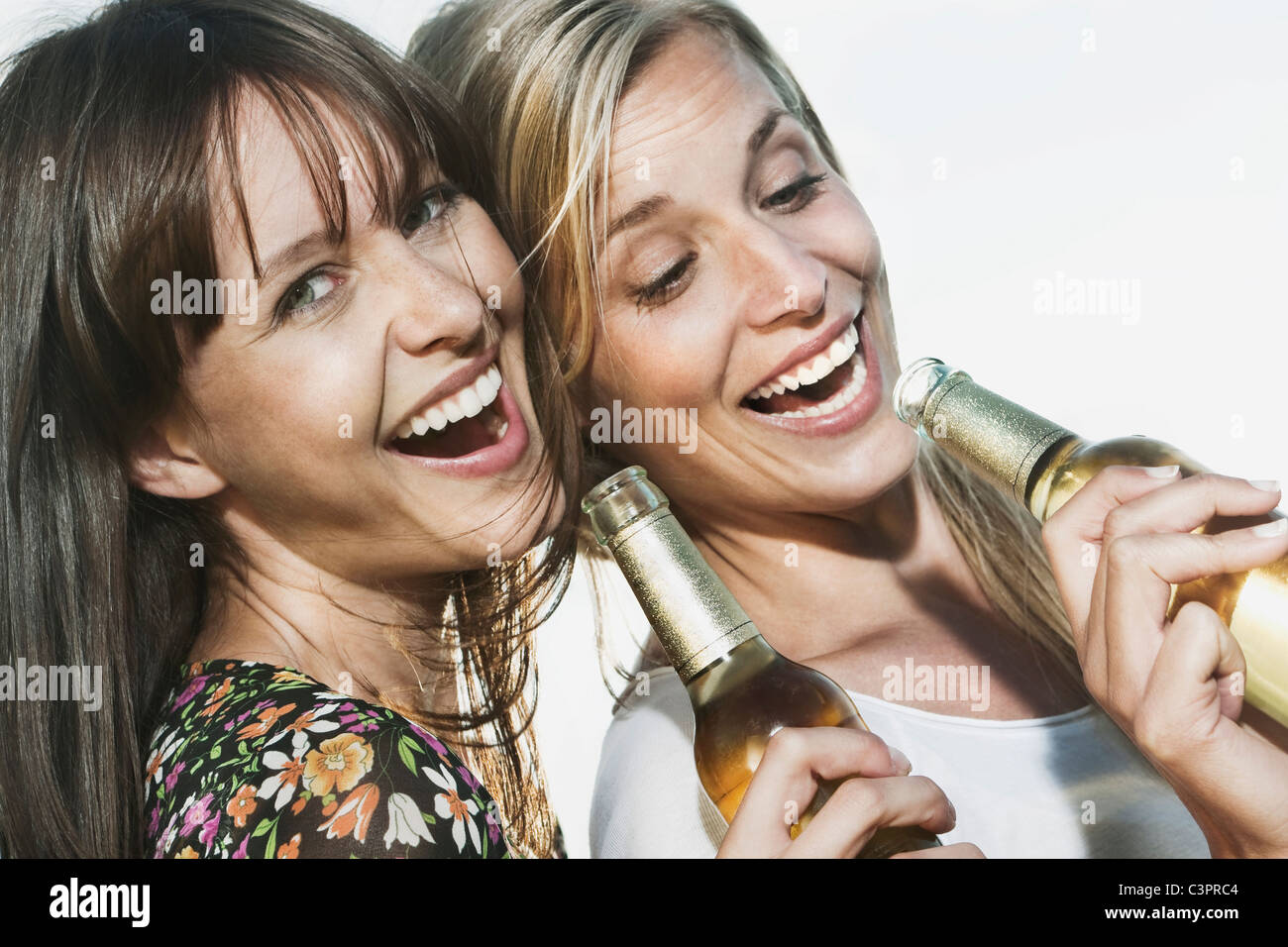 Germany, Cologne, Women enjoying beer, smiling Stock Photo - Alamy