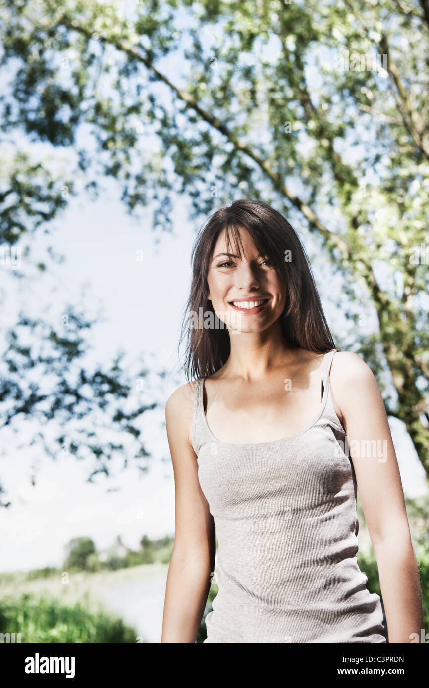 Germany, Cologne, Young woman smiling, portrait Stock Photo - Alamy