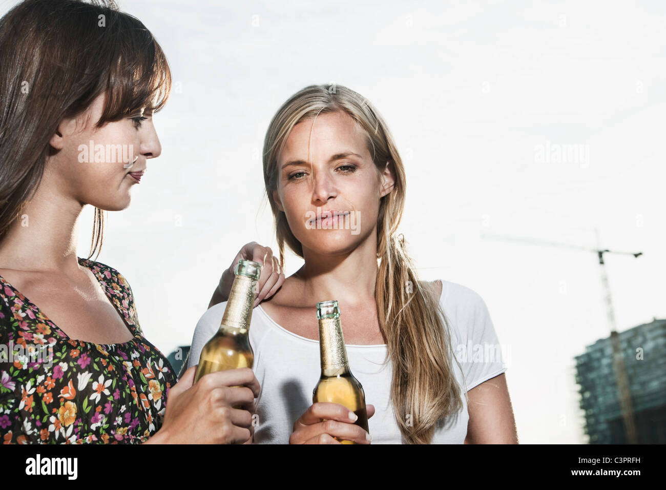 Germany, Cologne, Women with beer bottles Stock Photo - Alamy