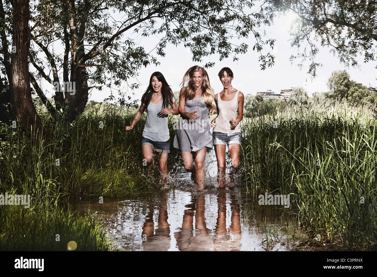 Germany, Cologne, Women running in water Stock Photo - Alamy