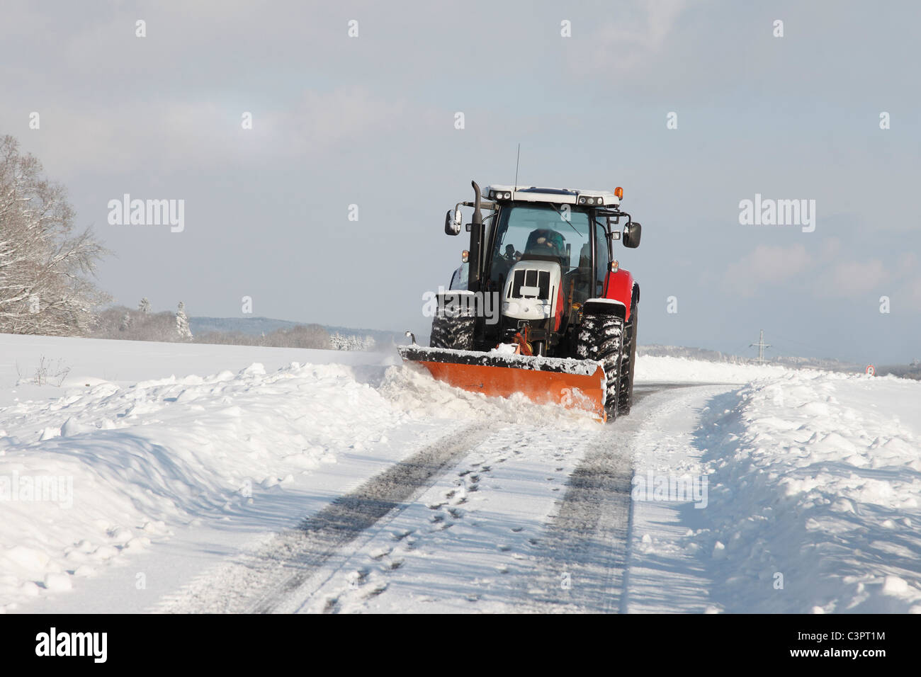 Germany, Tractor with snow plough Stock Photo - Alamy