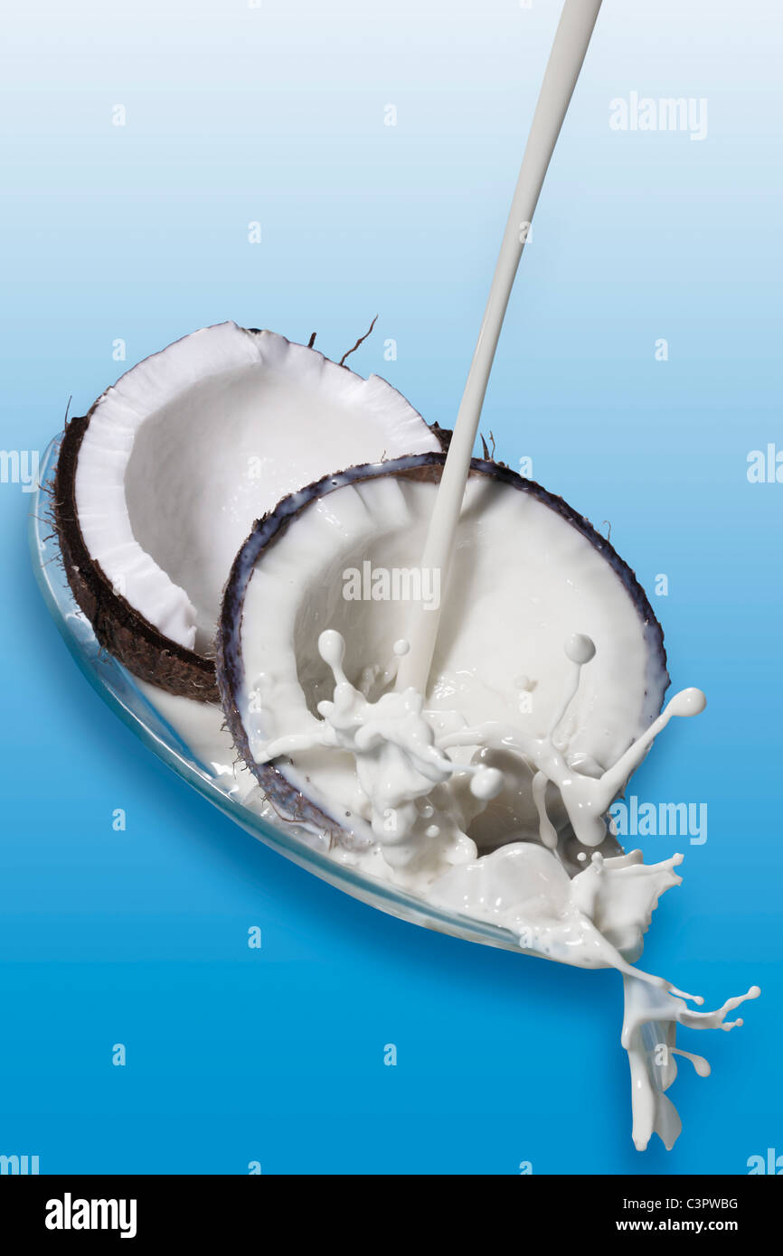 Coconut milk pouring on coconut, close up Stock Photo - Alamy