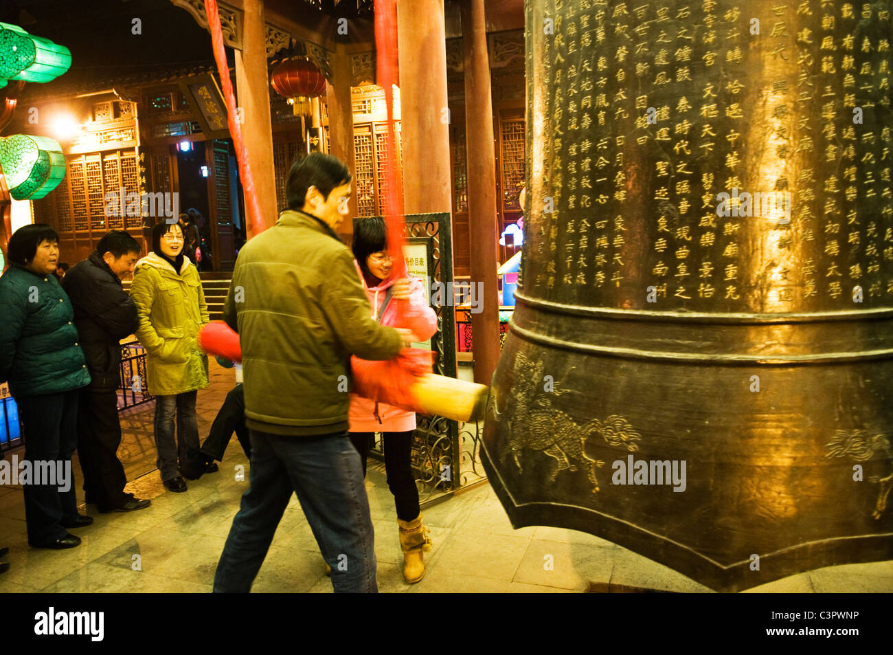 Striking the bell during Chinese new year's celebrations Stock Photo ...