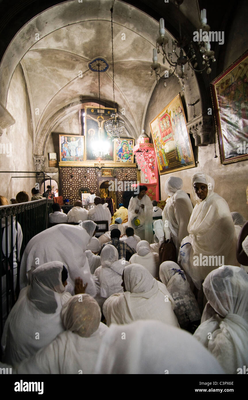 Ethiopian pilgrims and Ethiopian Orthodox priests praying inside the ...