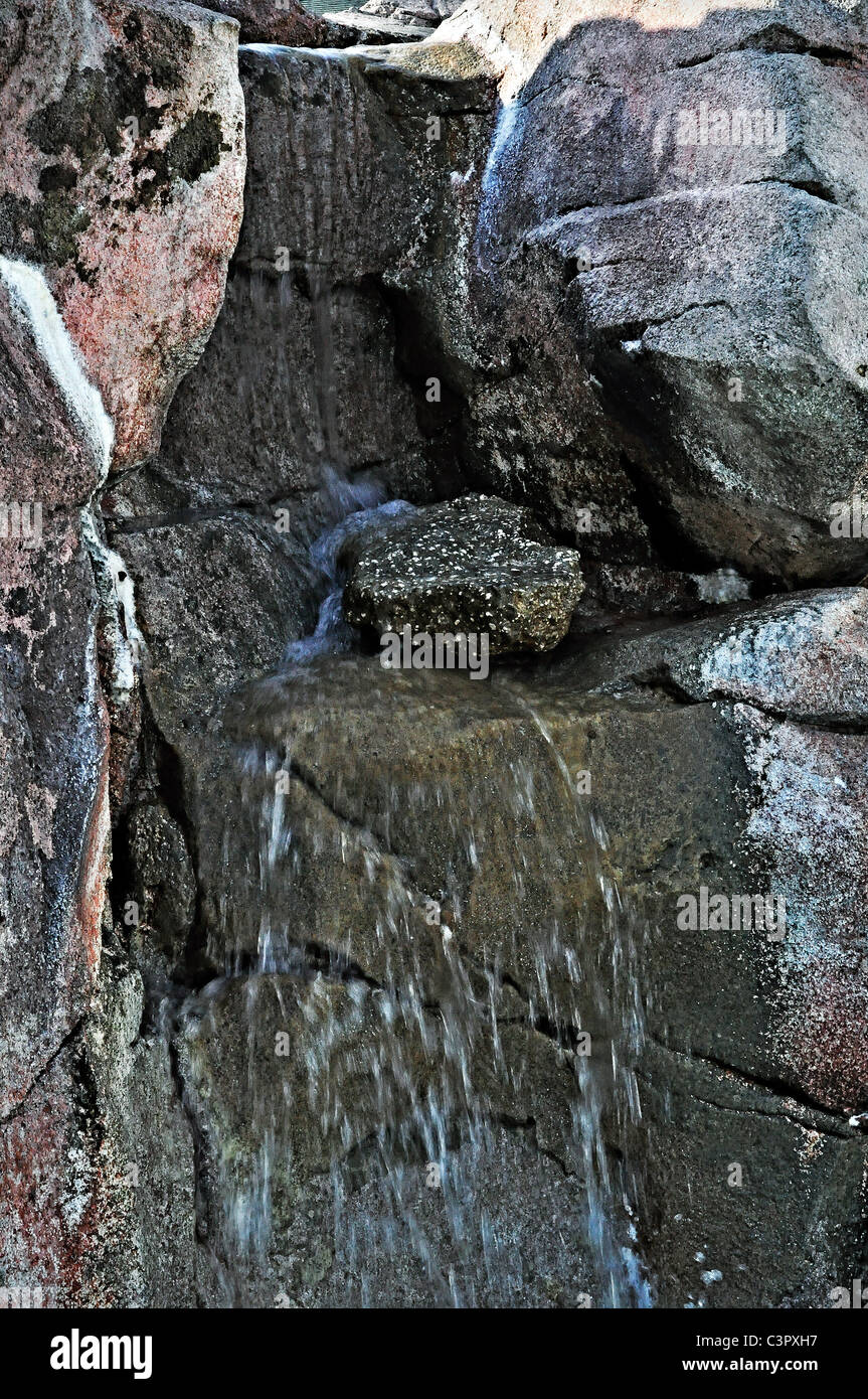 At the beach, water falling down the rocks Stock Photo - Alamy