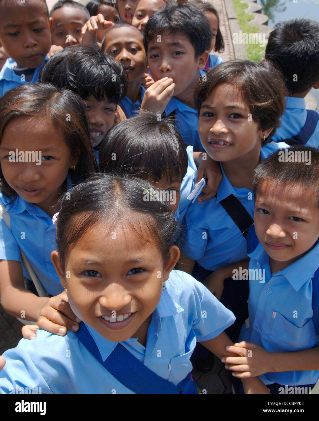 Balinese school children pose for the camera, Candidasa, Bali ...