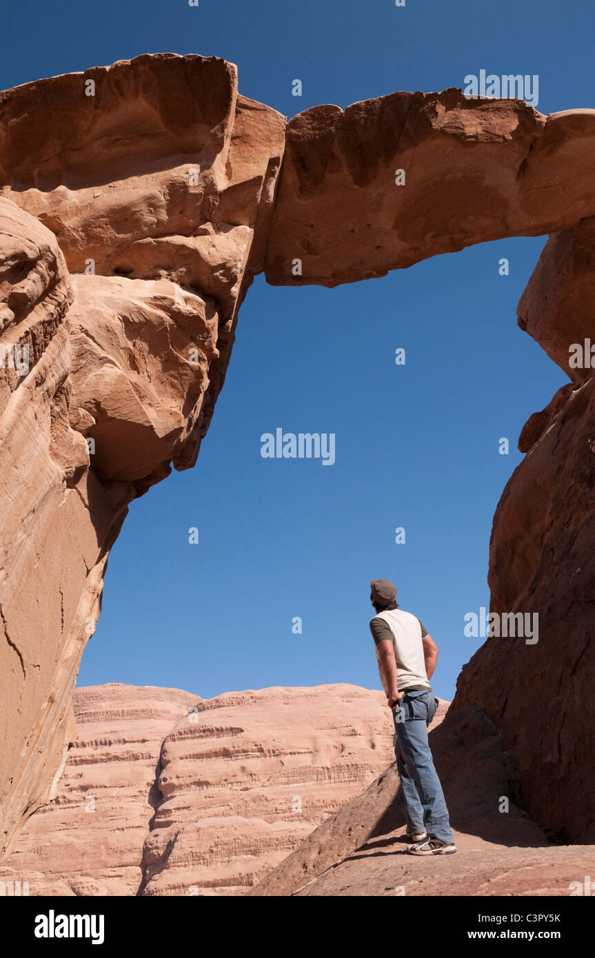 Man looking at rock formation Stock Photo - Alamy