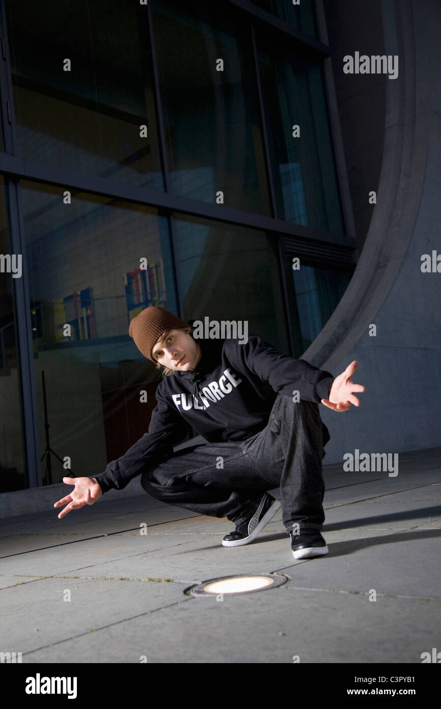 Man crouching, gesturing, portrait Stock Photo - Alamy