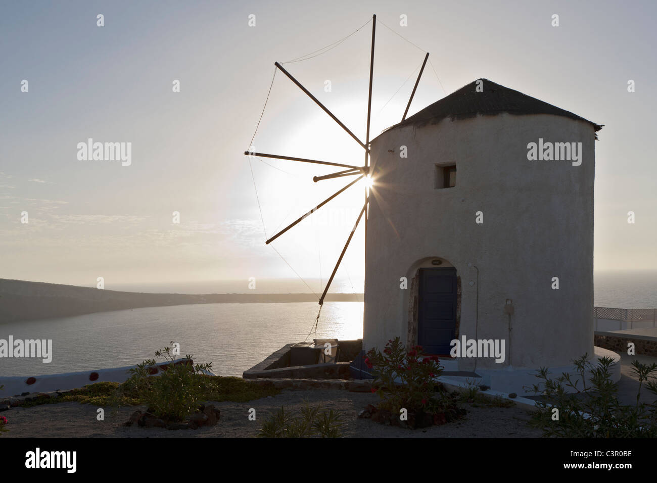 Greece, Cyclades, Thira, Santorini, Oia, View of windmill at sunset ...