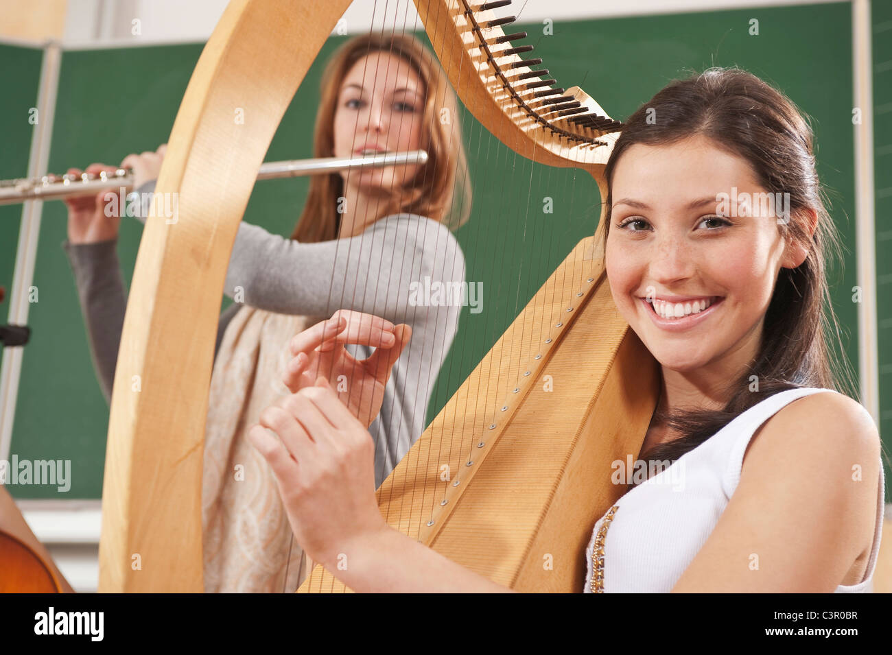 Germany, Emmering, Teenage girl and young woman playing musical ...