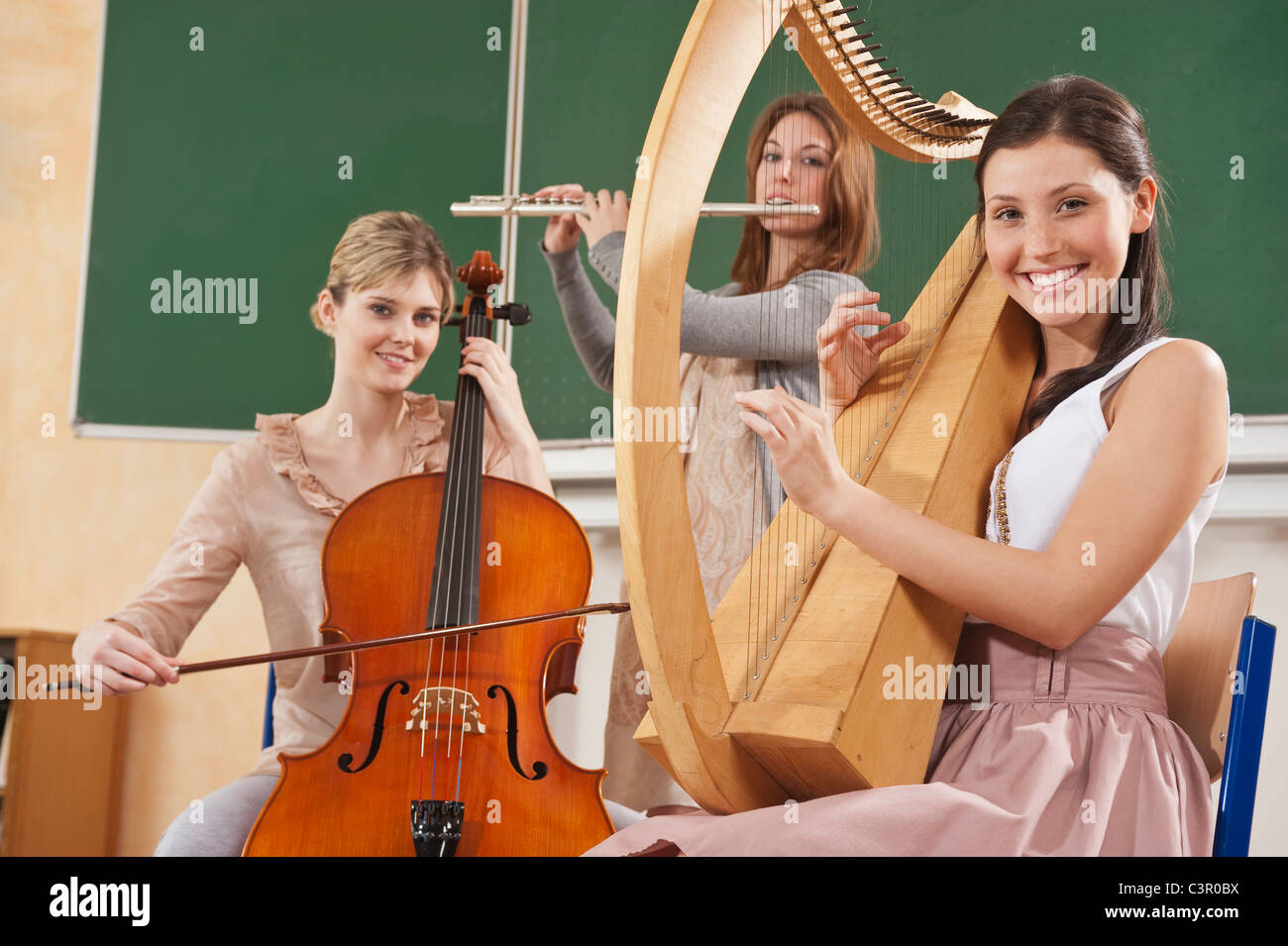 Germany, Emmering, Teenage girl and young women playing musical ...