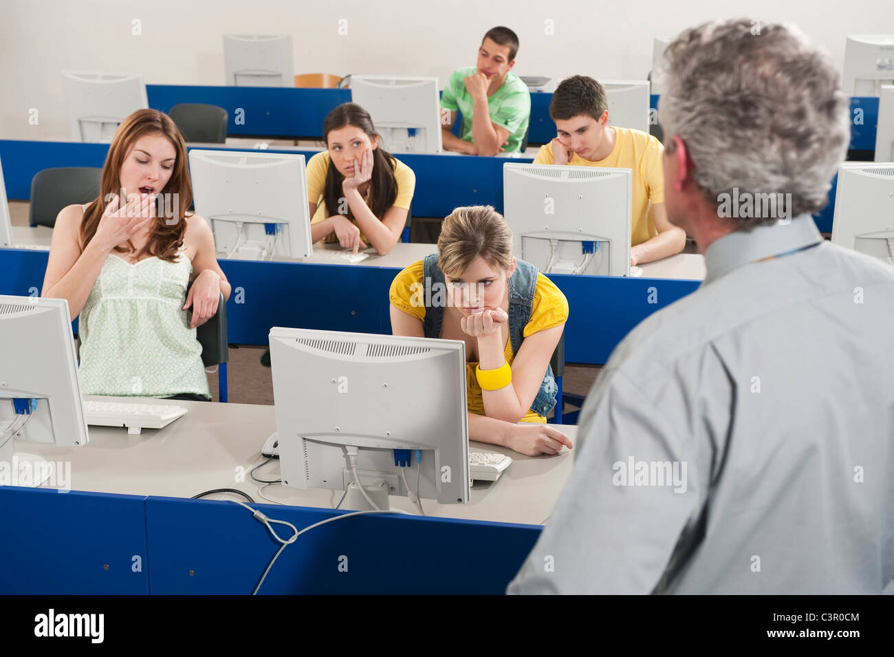 Germany, Emmering, Students getting bored in computer lab Stock Photo ...