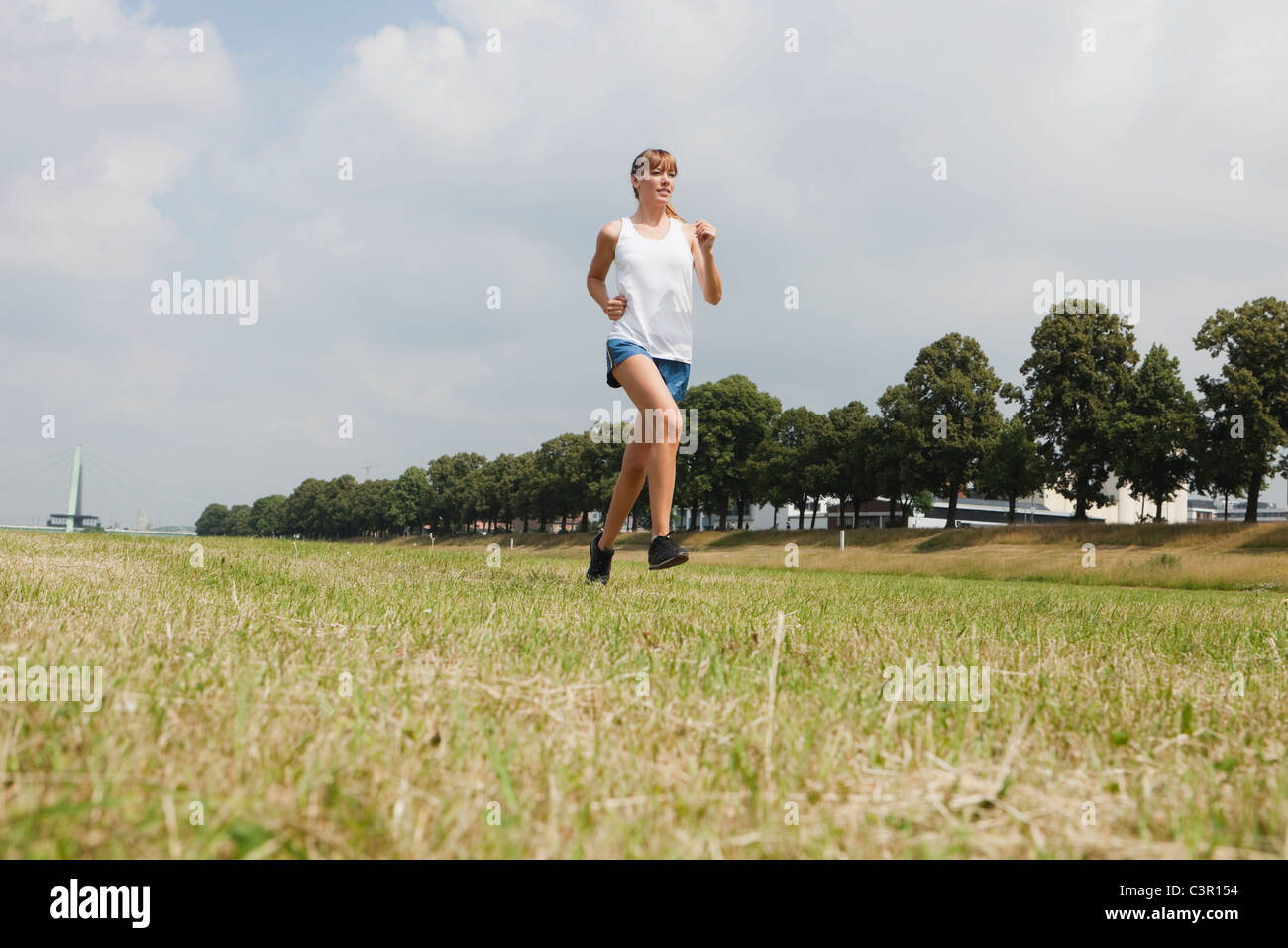 Germany, Cologne, Young woman jogging Stock Photo - Alamy