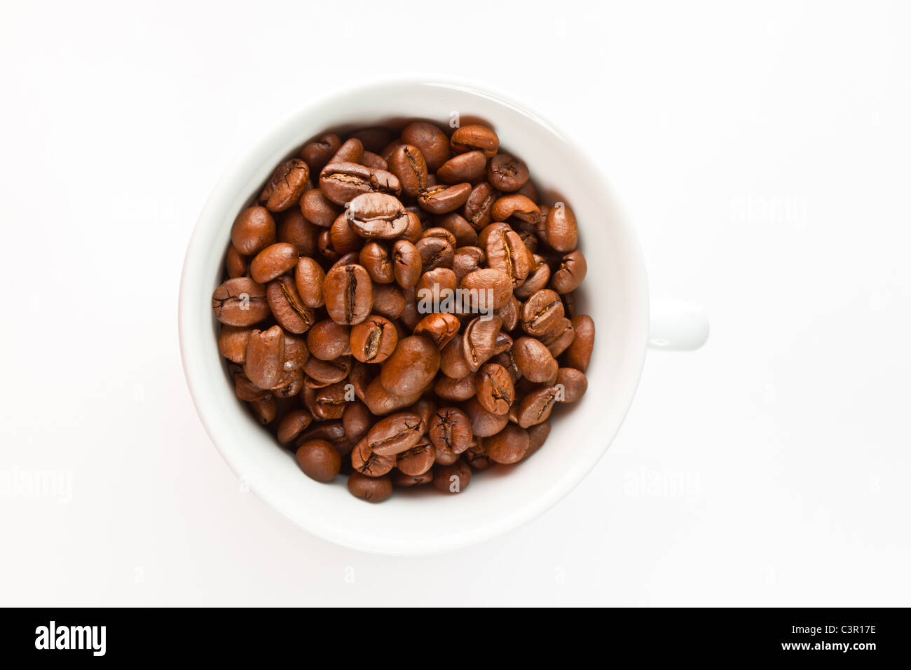 A cup of coffee seeds isolated on white Stock Photo - Alamy