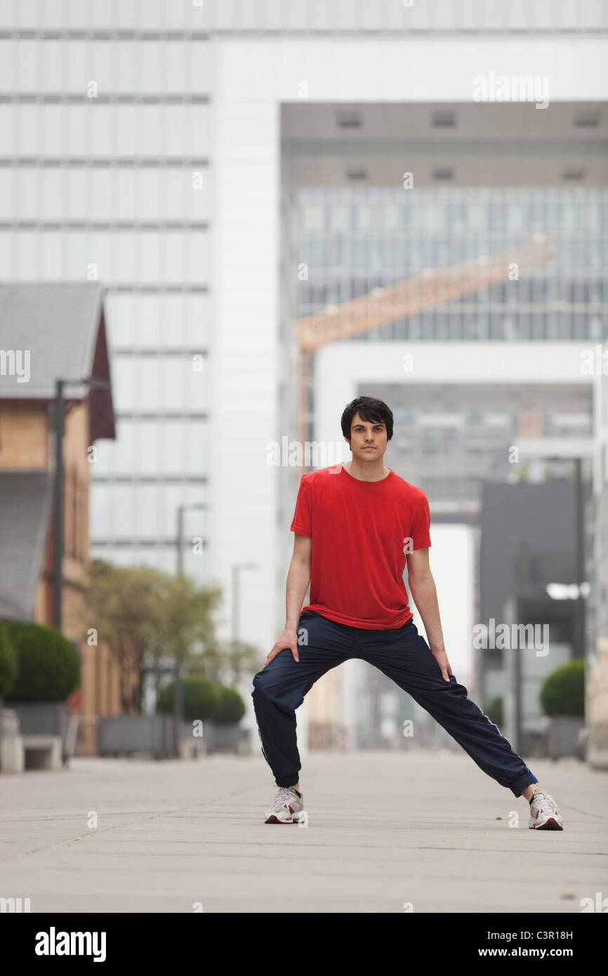 Germany, Cologne, Young man doing exercise, portrait Stock Photo - Alamy