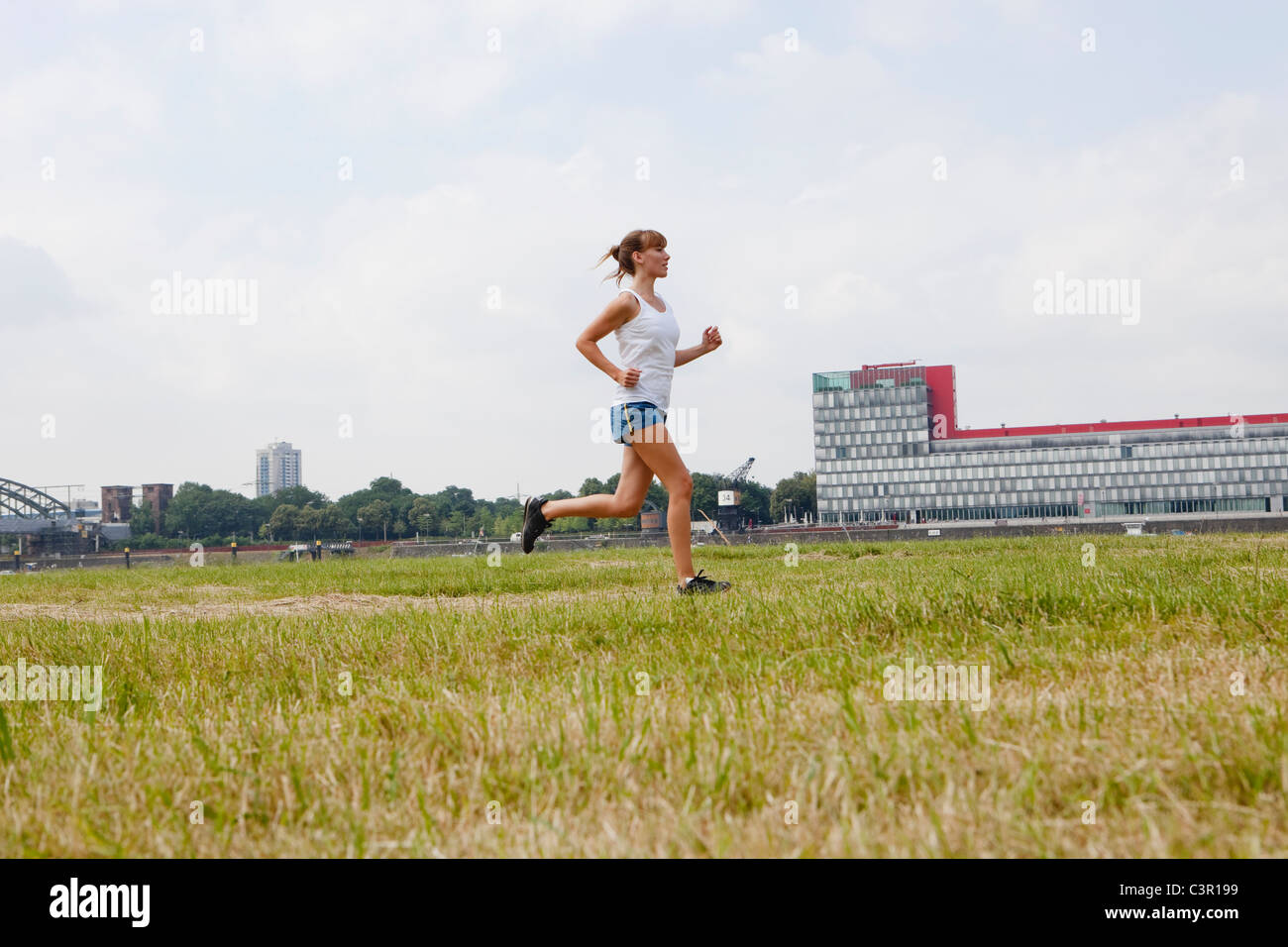 Germany, Cologne, Young woman jogging Stock Photo - Alamy