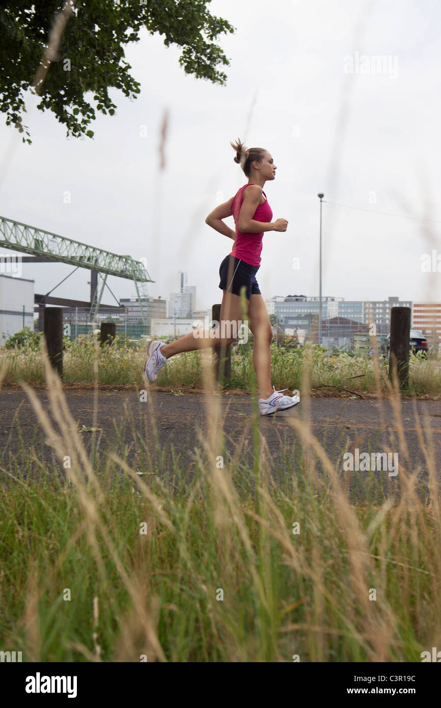 Germany, Cologne, Young woman jogging Stock Photo - Alamy