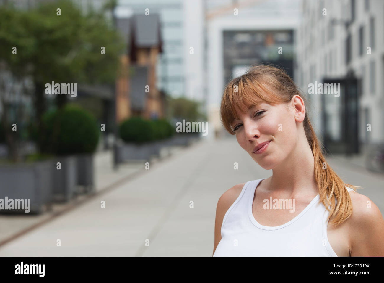 Germany, Cologne, Young woman smiling, portrait Stock Photo - Alamy
