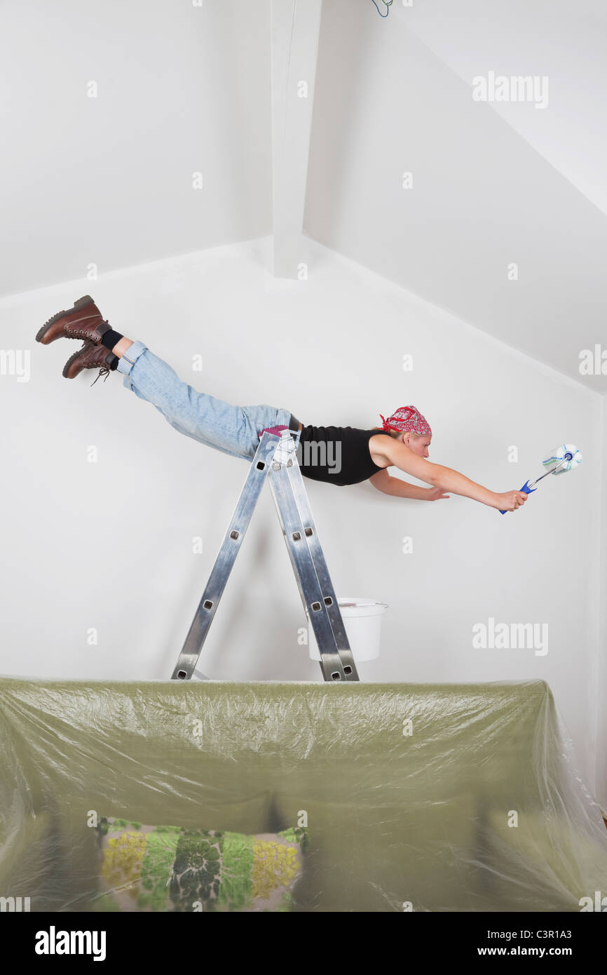 Mature woman balancing on ladder hi-res stock photography and images ...