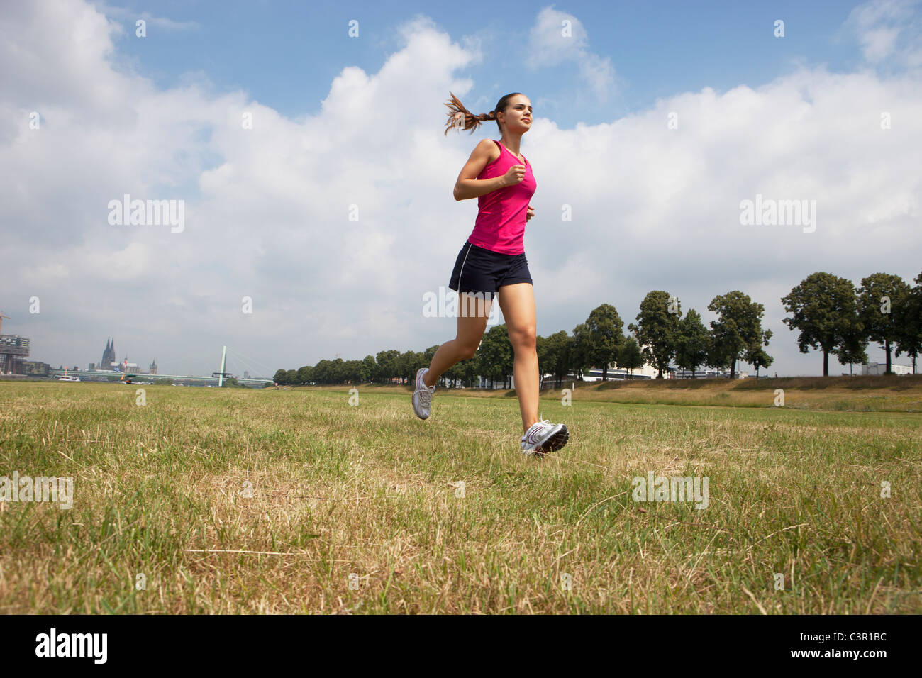 Germany, Cologne, Young woman jogging Stock Photo - Alamy