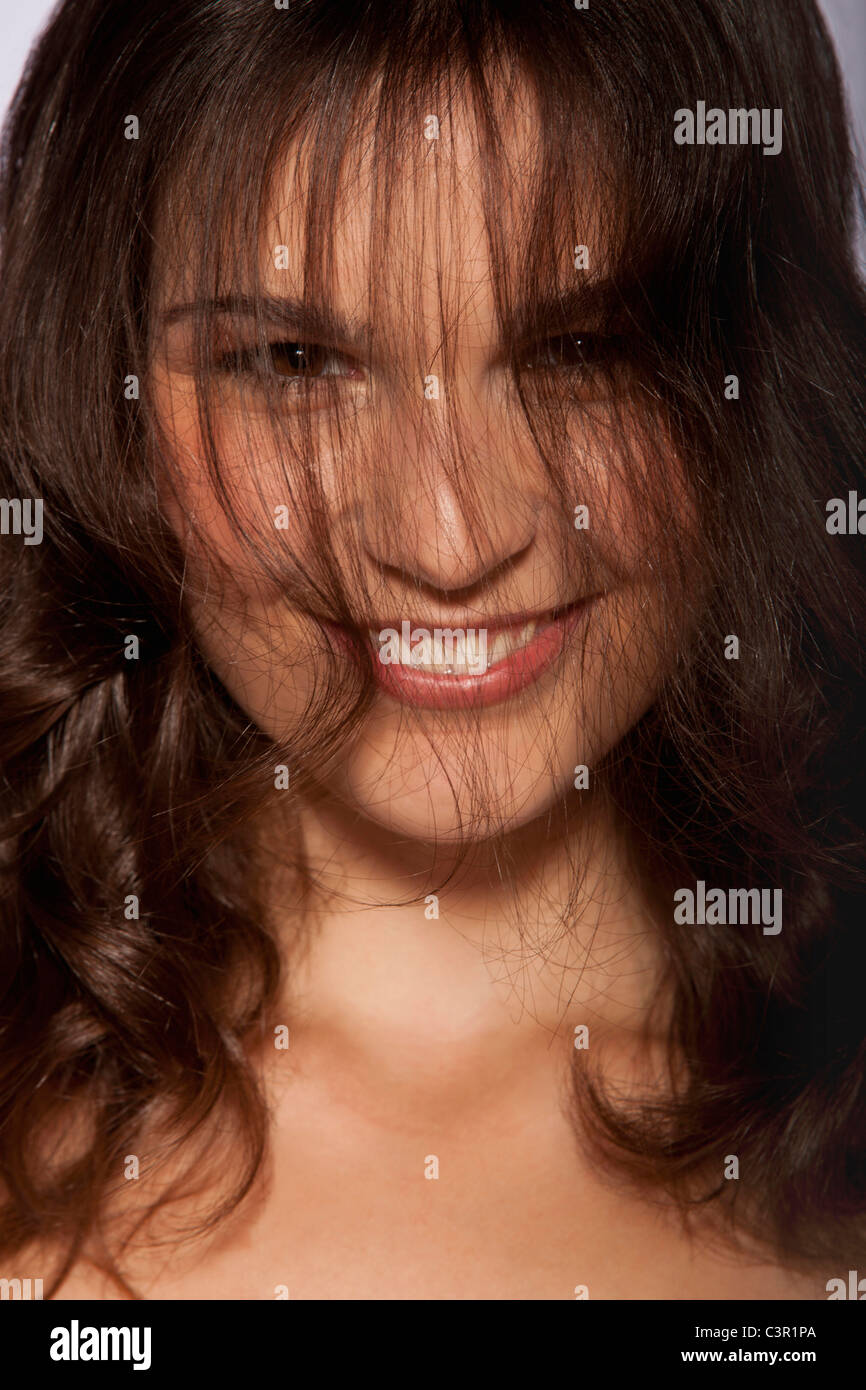 Young woman with hair over face, smiling, portrait Stock Photo - Alamy