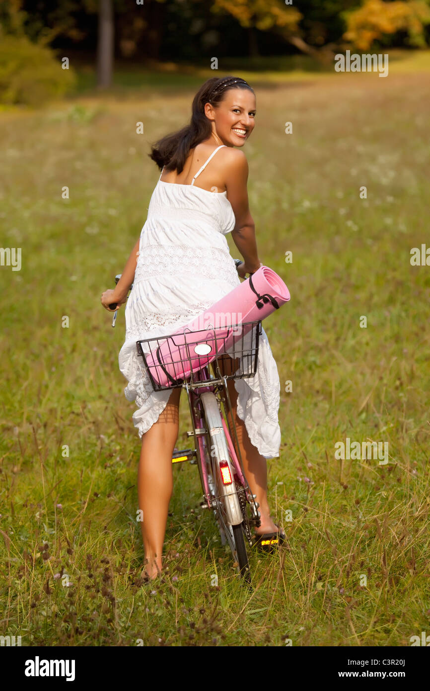 Germany, Bavaria, Woman on bicycle, smiling, portrait Stock Photo - Alamy