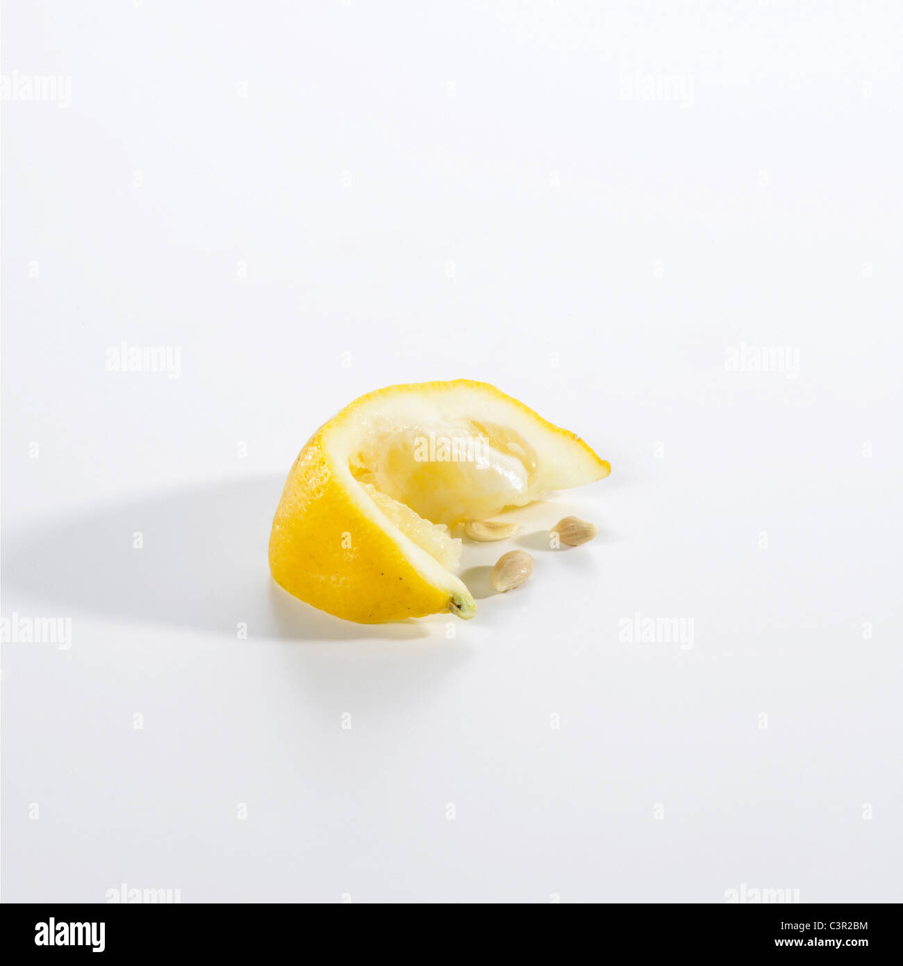 Squeezed lemon slice on white background Stock Photo - Alamy
