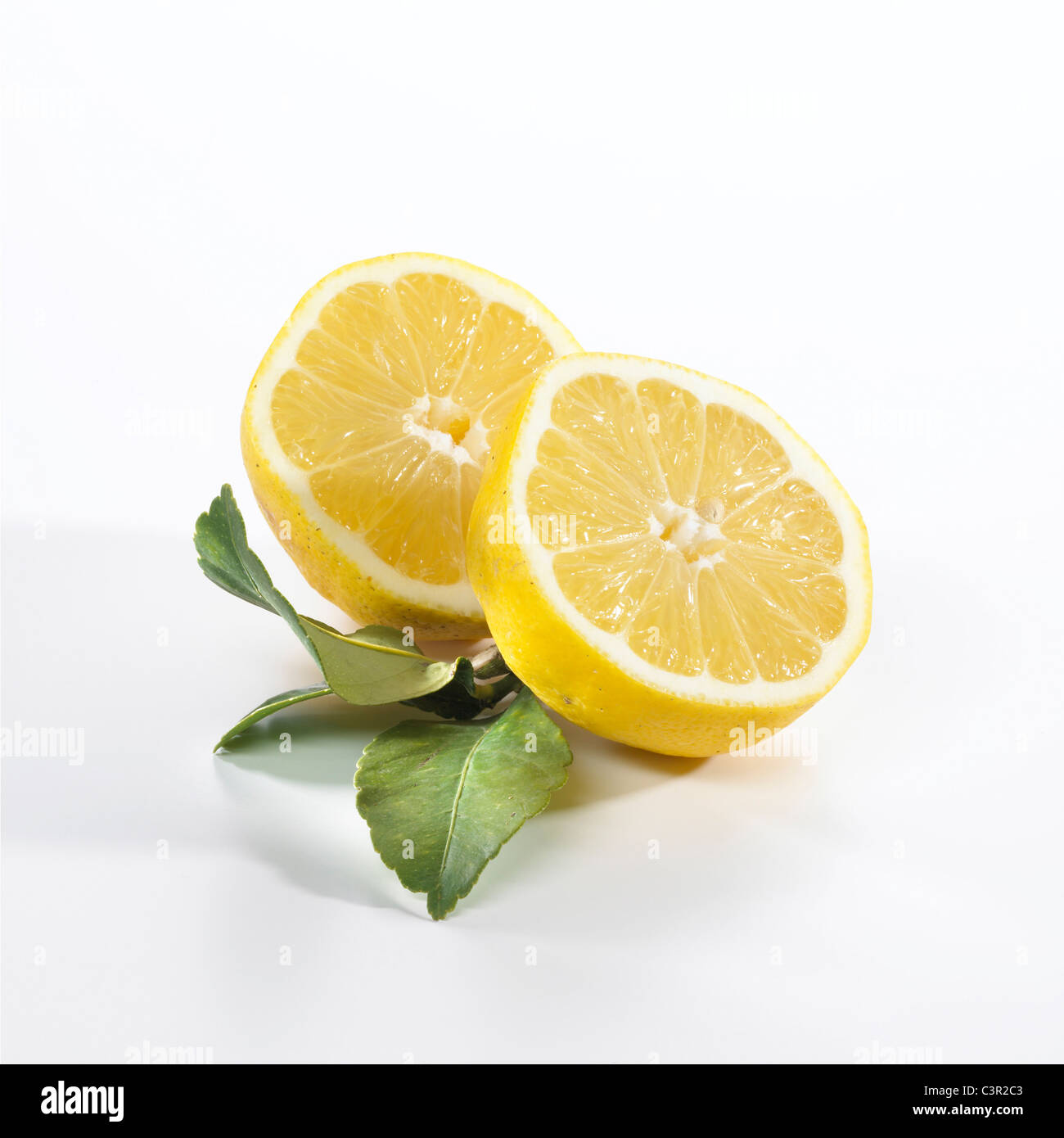 Cross section of lemon with leaf on white background Stock Photo - Alamy