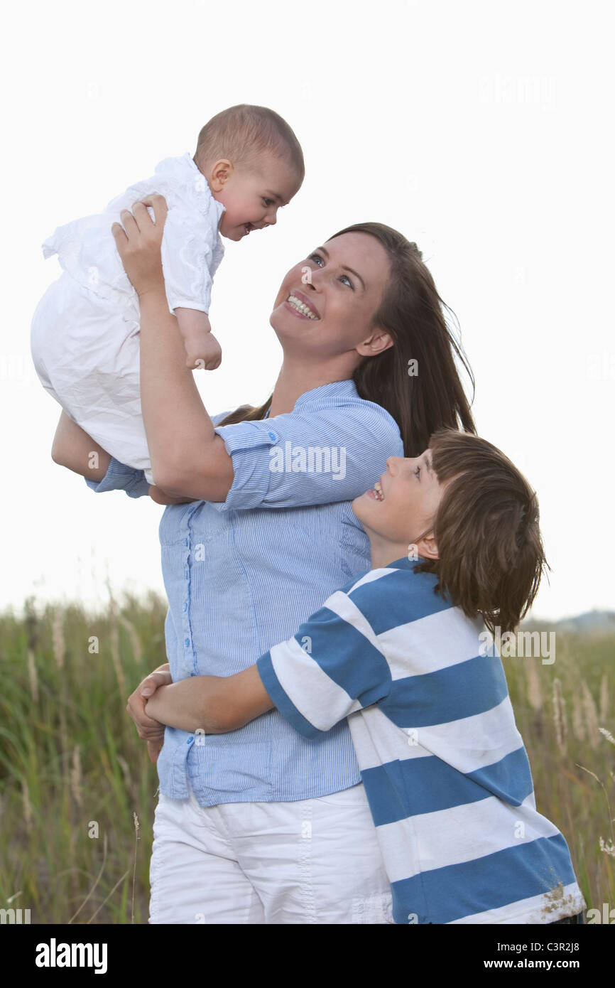 Germany, Bavaria, Mother with (2-5 months) baby girl and (10-11 Years ...