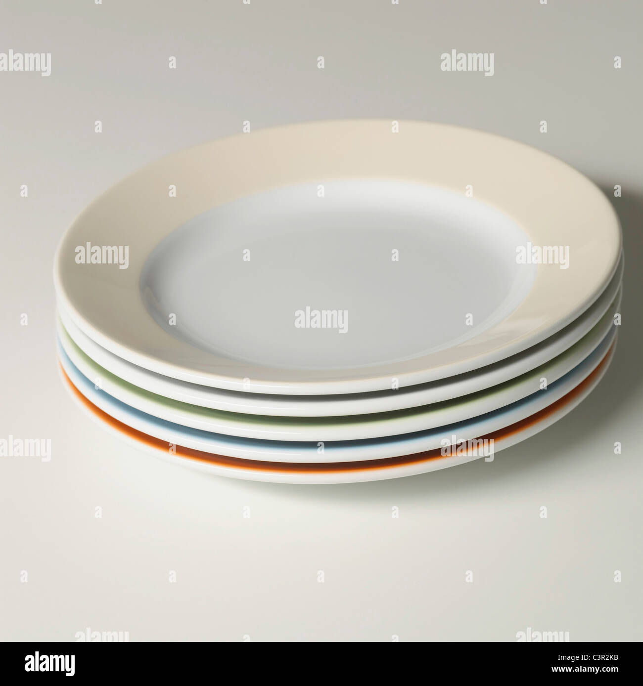 Stack of plates on white background Stock Photo - Alamy