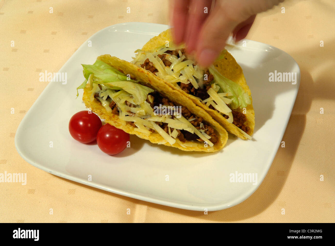 Two mexican tacos on white plate with tomatos Stock Photo - Alamy