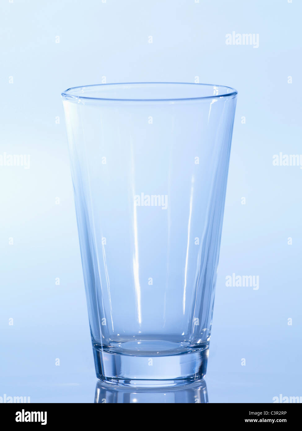 Empty glass against blue background, close-up Stock Photo - Alamy
