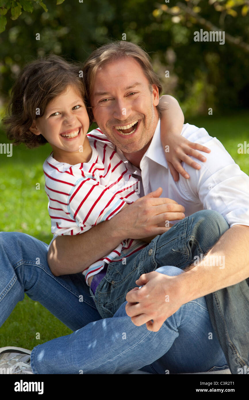 Germany, Bavaria, Father and daughter (8-9 Years) having fun at picnic ...