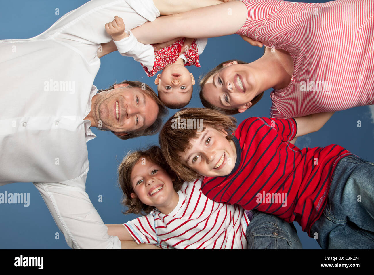 Germany, Bavaria, Family standing in huddle, smiling, portrait Stock ...