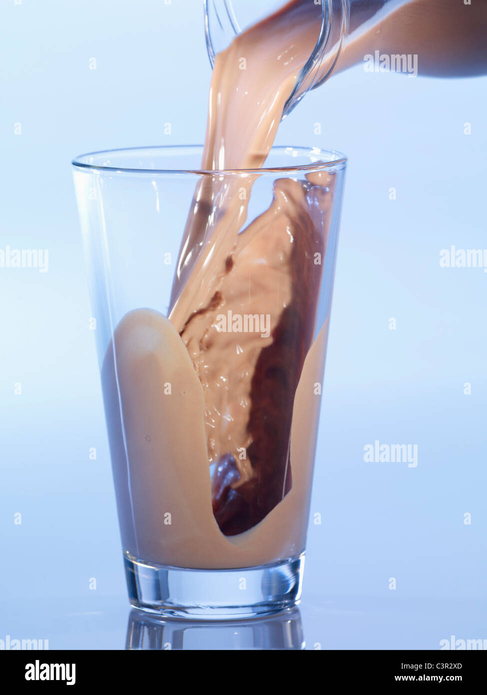 Pouring chocolate milkshake in glass, close-up Stock Photo - Alamy